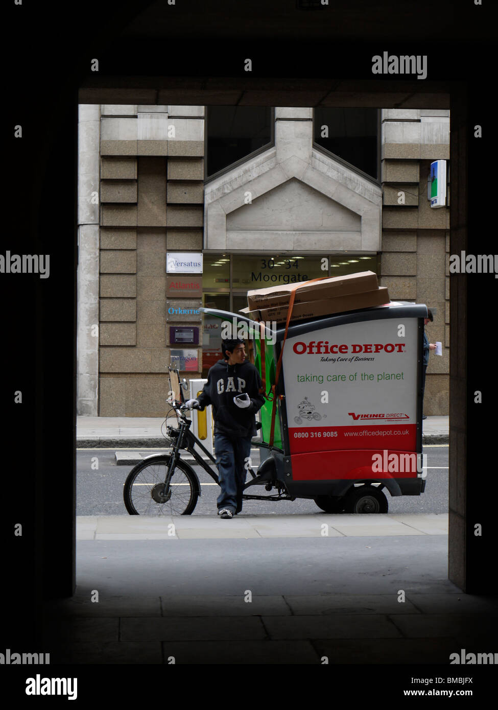 An environmentally friendly Office Depot delivery tricycle with pile of ...