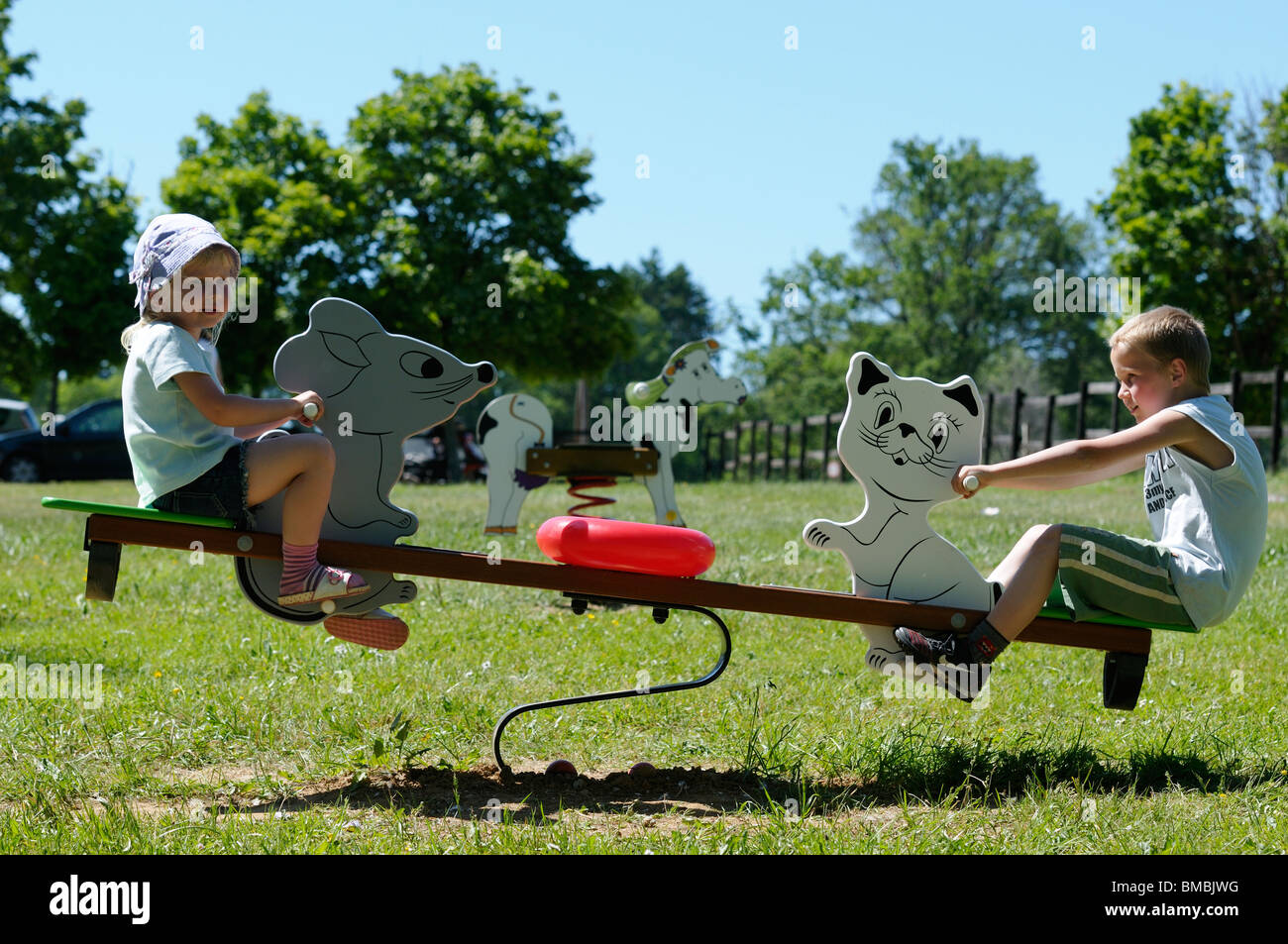 Stock photo of two children playing on a see-saw in a playground Stock ...