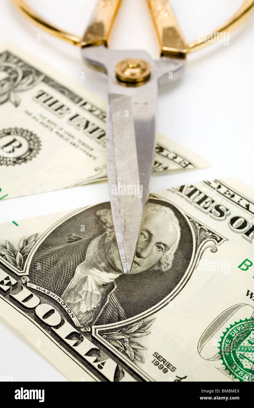 Scissors cutting dollars hi-res stock photography and images - Alamy