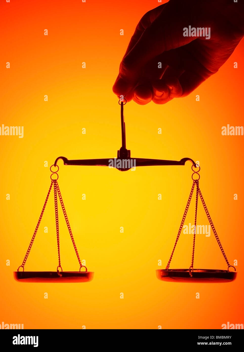 Scales on orange light background Stock Photo - Alamy