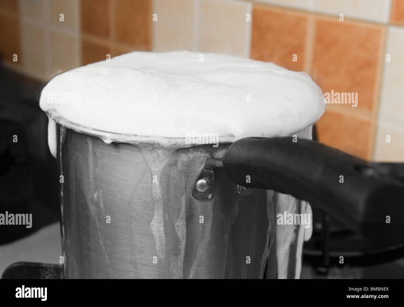 Milk boiling over a pan Stock Photo - Alamy