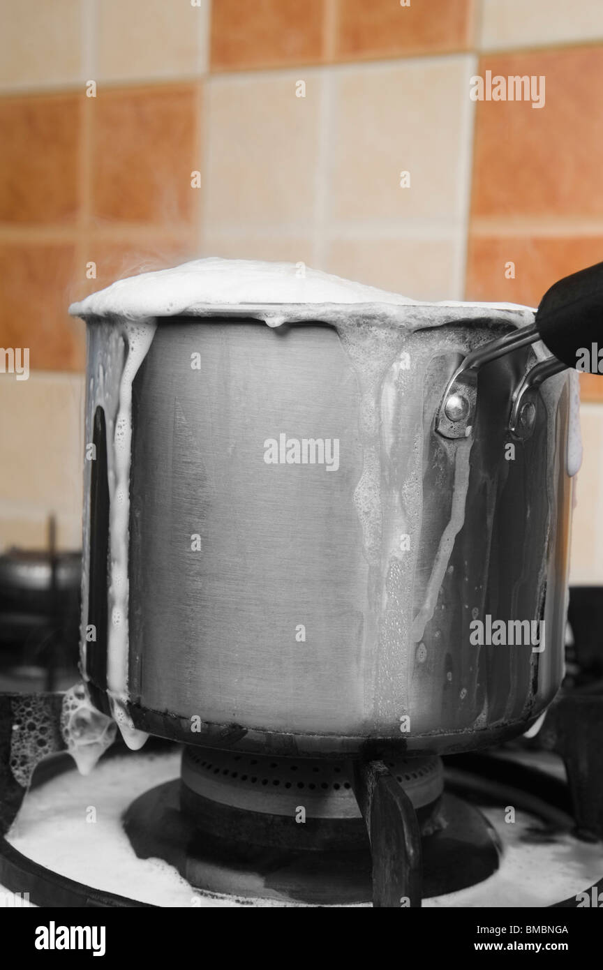 Milk boiling over a pan Stock Photo - Alamy