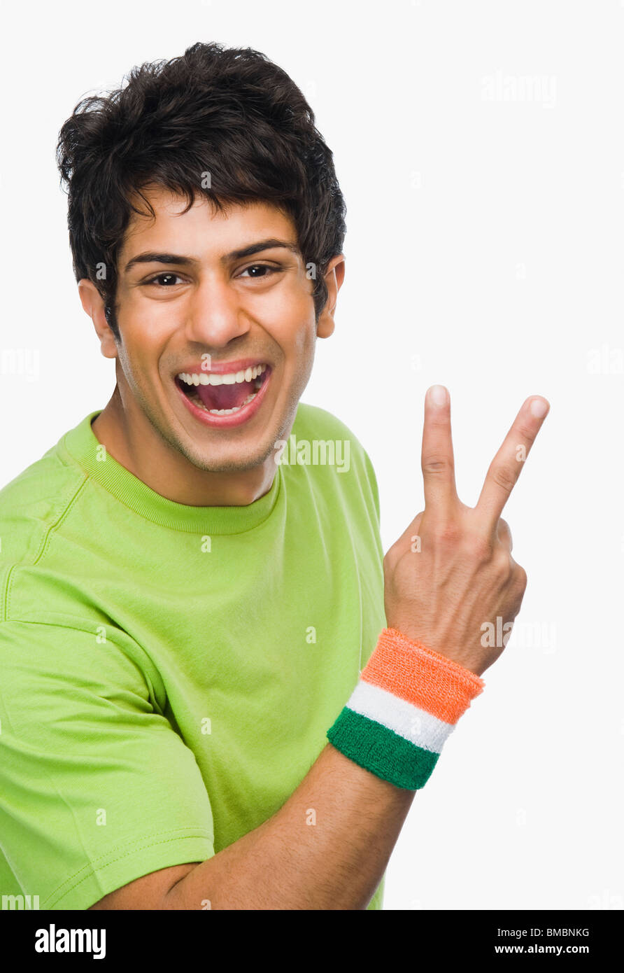 Portrait of a man showing peace sign Stock Photo - Alamy