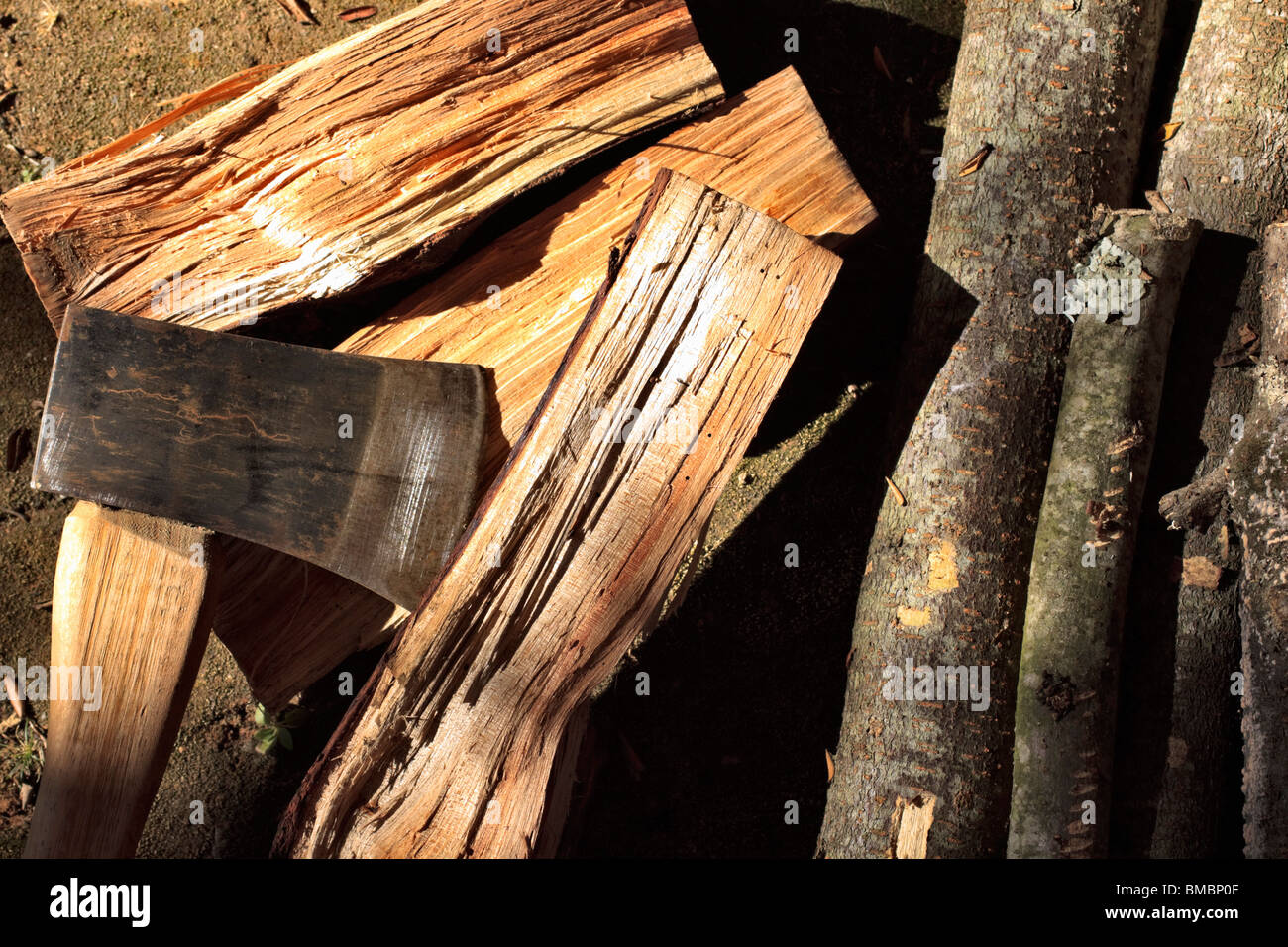 Axe lying beside chopped firewood Stock Photo - Alamy