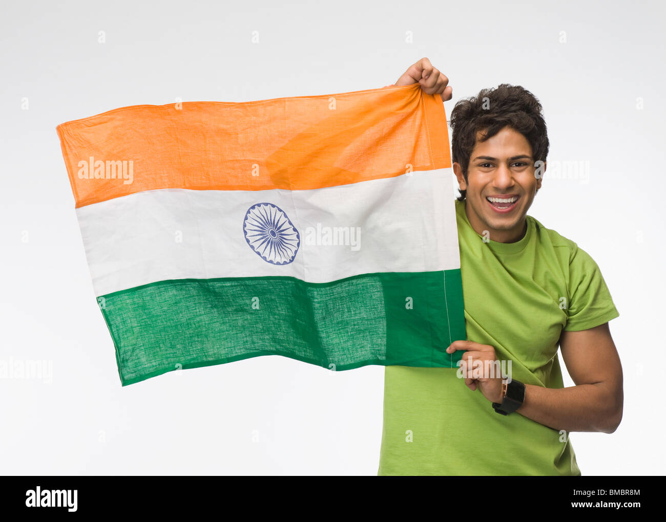 Portrait of a man holding aloft an Indian flag Stock Photo - Alamy