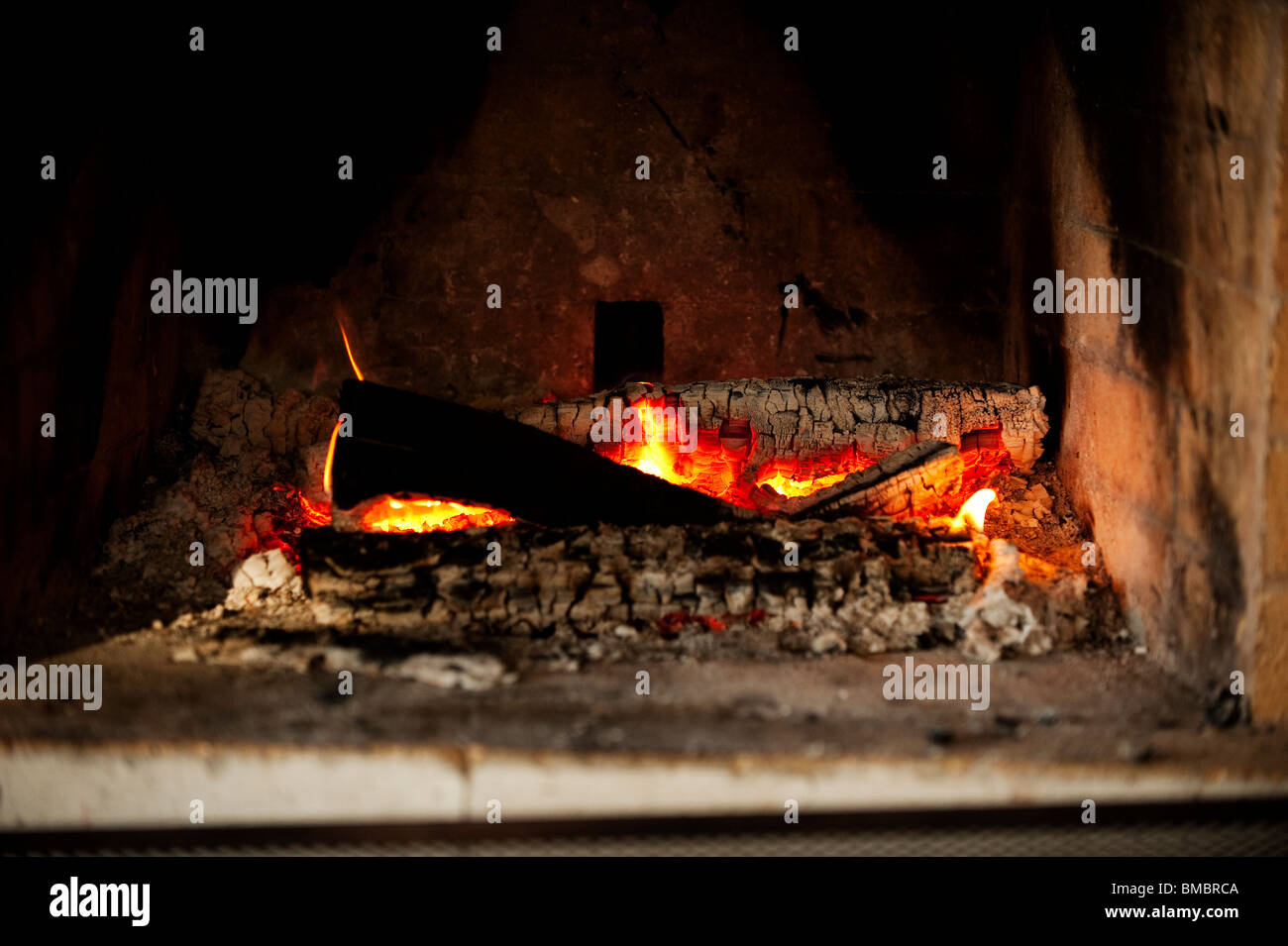 Fireplace with burning logs Stock Photo - Alamy