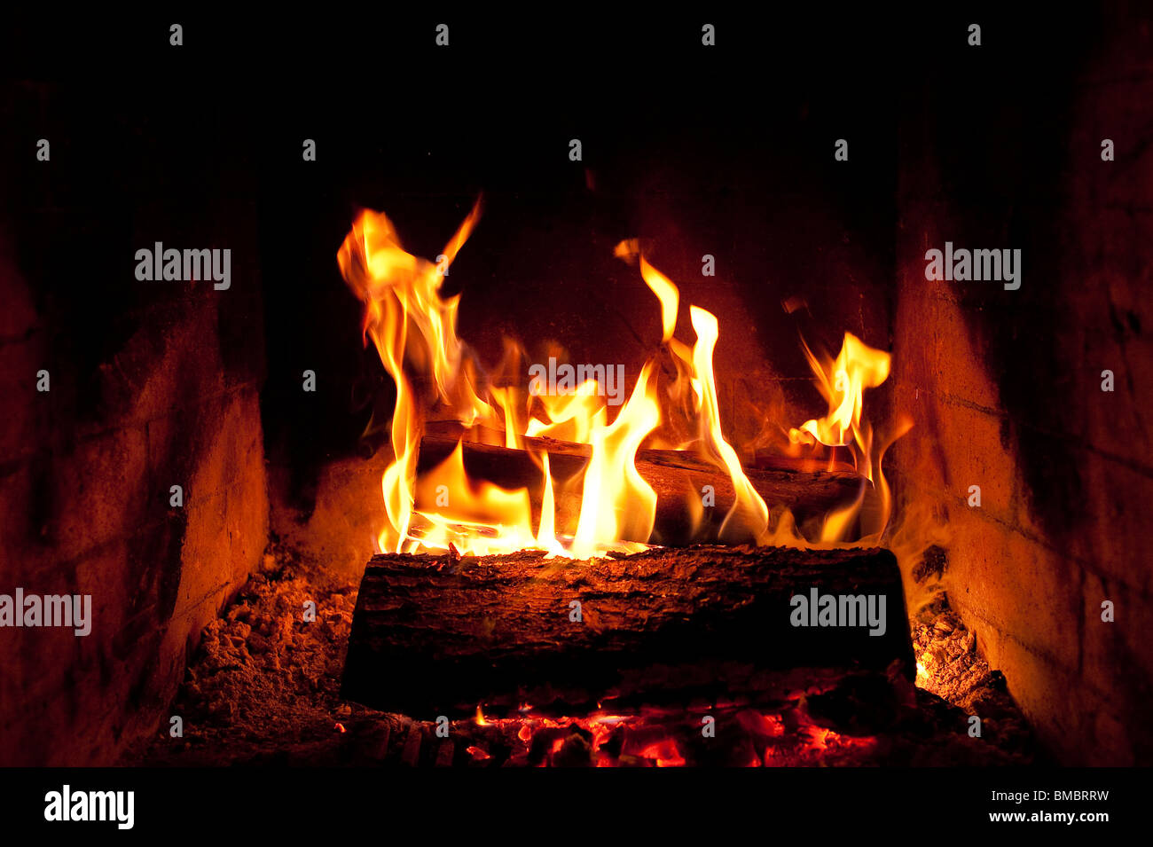 Fireplace with burning logs Stock Photo - Alamy
