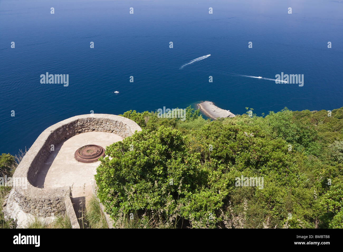second world war bunker stands between arbutus tree over Mediterranean ...
