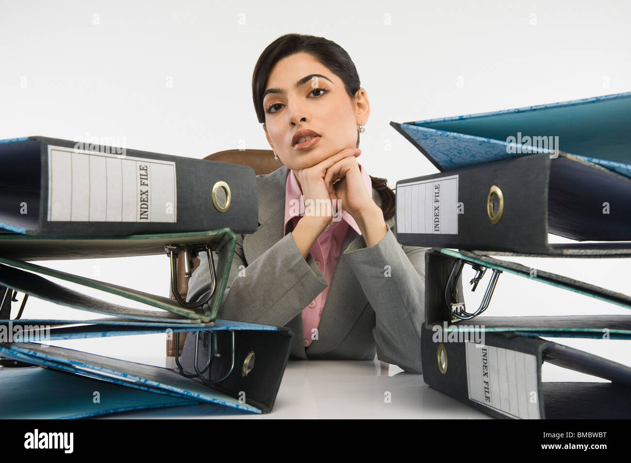 Stack of ring binders in front of a businesswoman Stock Photo - Alamy