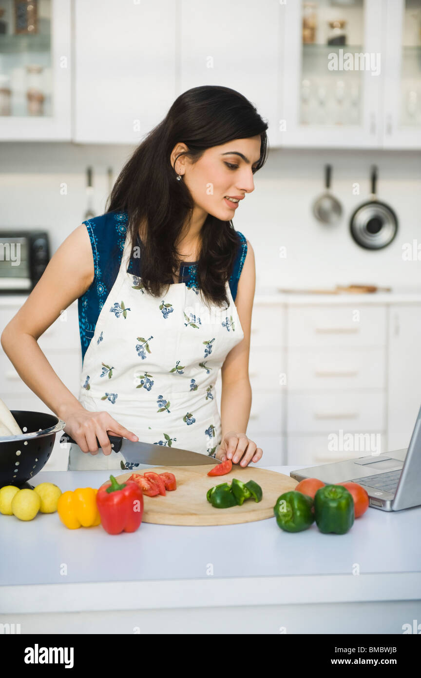 Woman cooking with the recipe on a laptop Stock Photo - Alamy