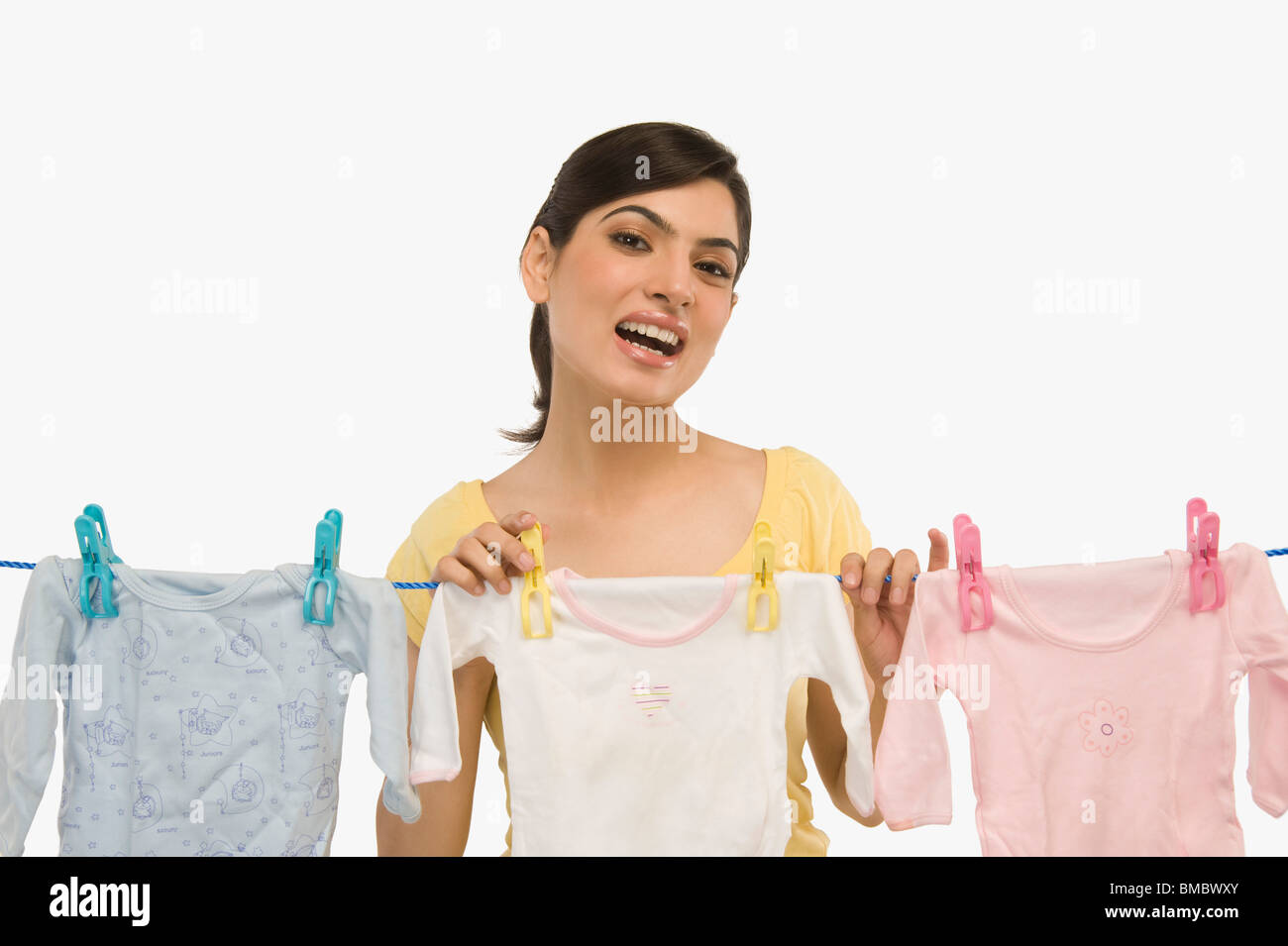 Woman hanging clothes on a clothesline Stock Photo - Alamy
