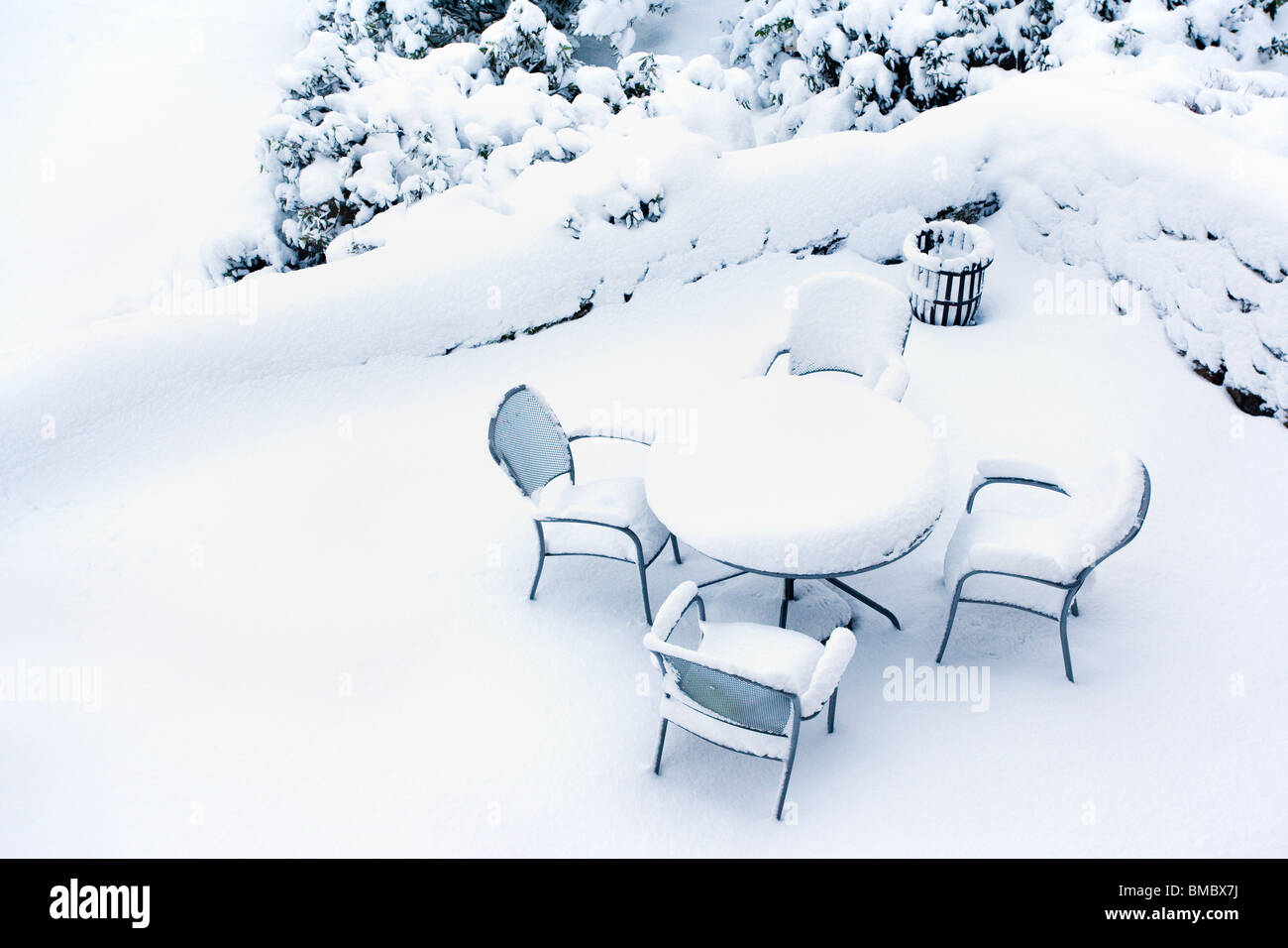 Garden snowscape, snow on picnic table, winter in UK Stock Photo - Alamy