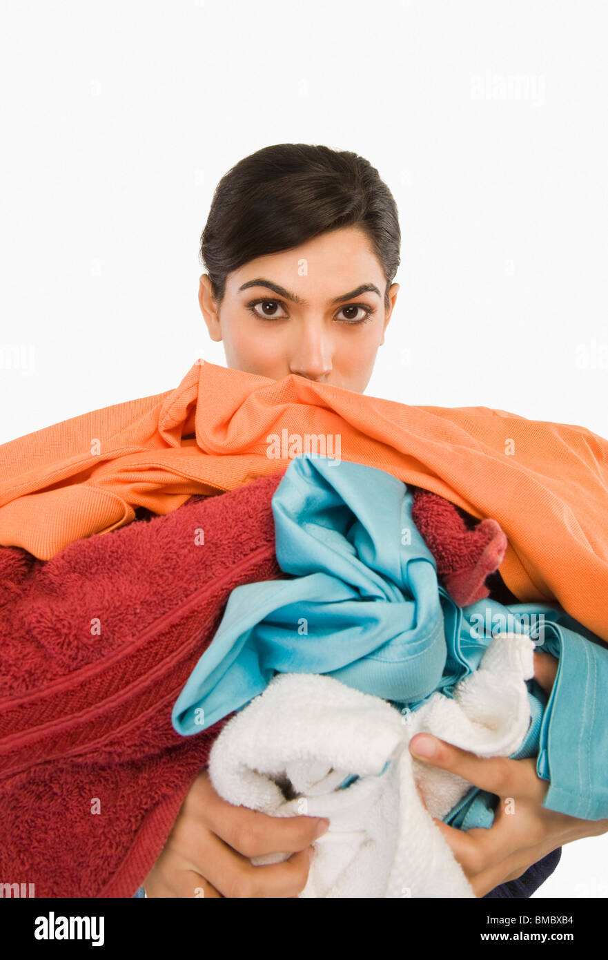 Woman holding clothes Stock Photo - Alamy