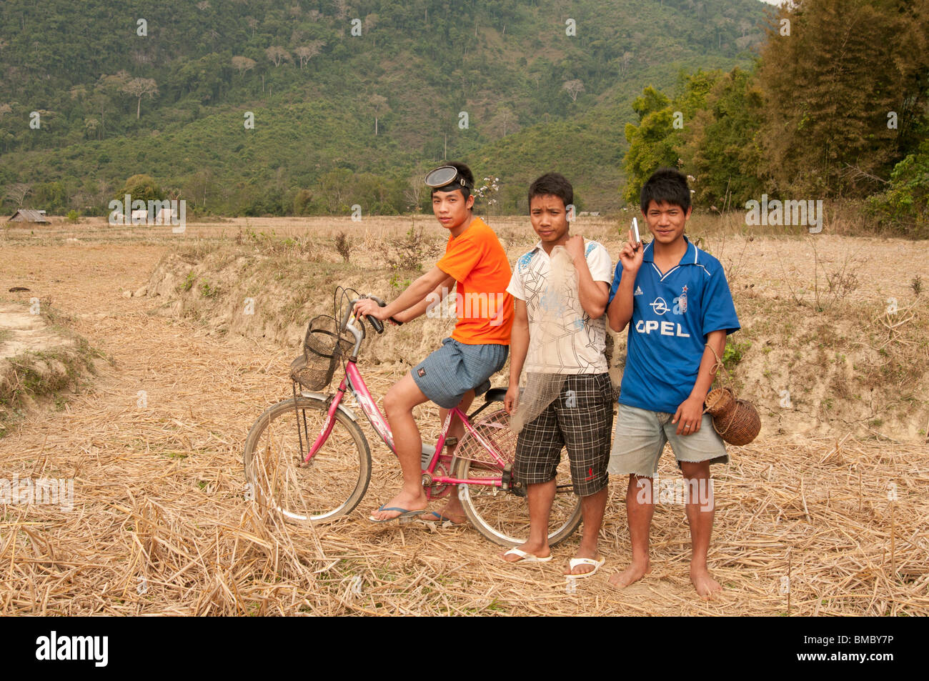 Lao boys cross a paddy field in the mountains of Muang Ngoi Laos Stock ...