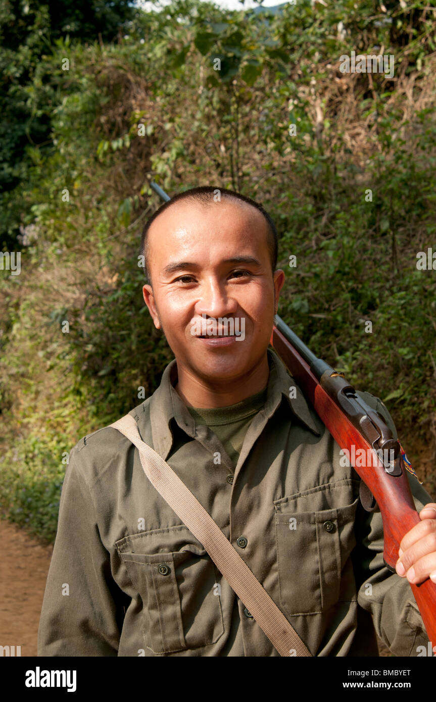 A Lao man with his gun along a jungle trail in Vong Xai province of ...