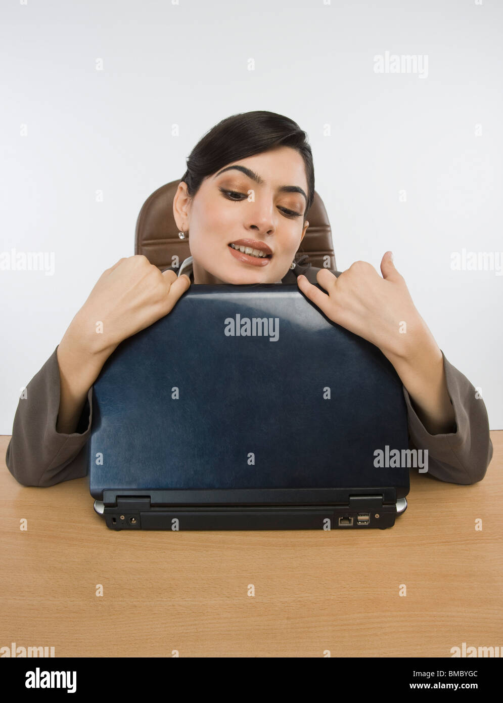 Businesswoman hugging a laptop Stock Photo - Alamy