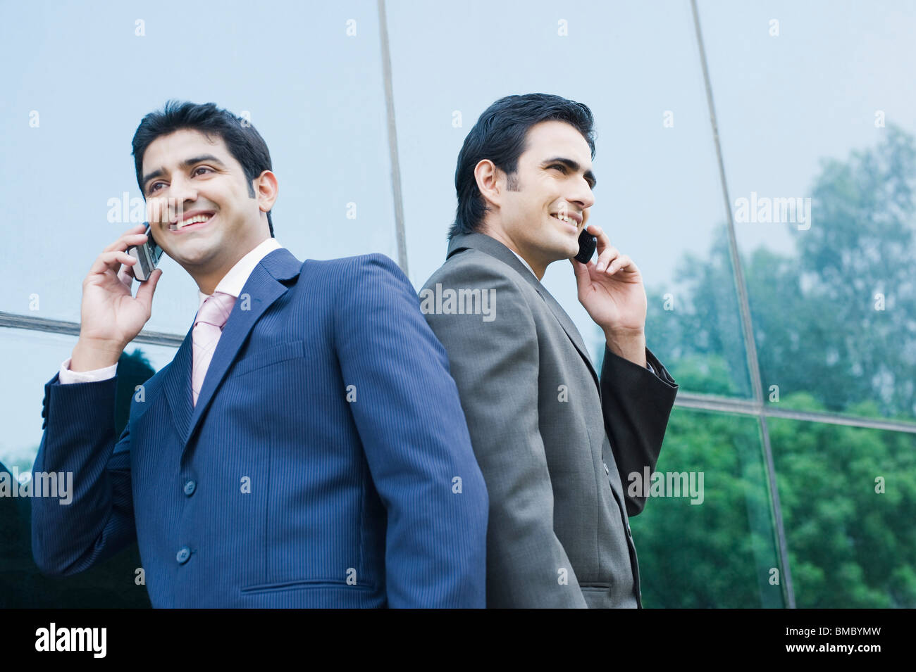 Two businessmen using cell phones hi-res stock photography and images ...