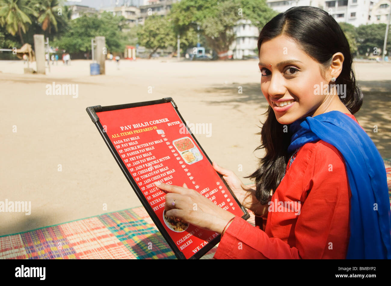 Woman holding a menu card Stock Photo - Alamy