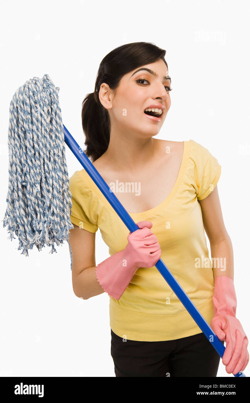 Woman holding a mop Stock Photo - Alamy