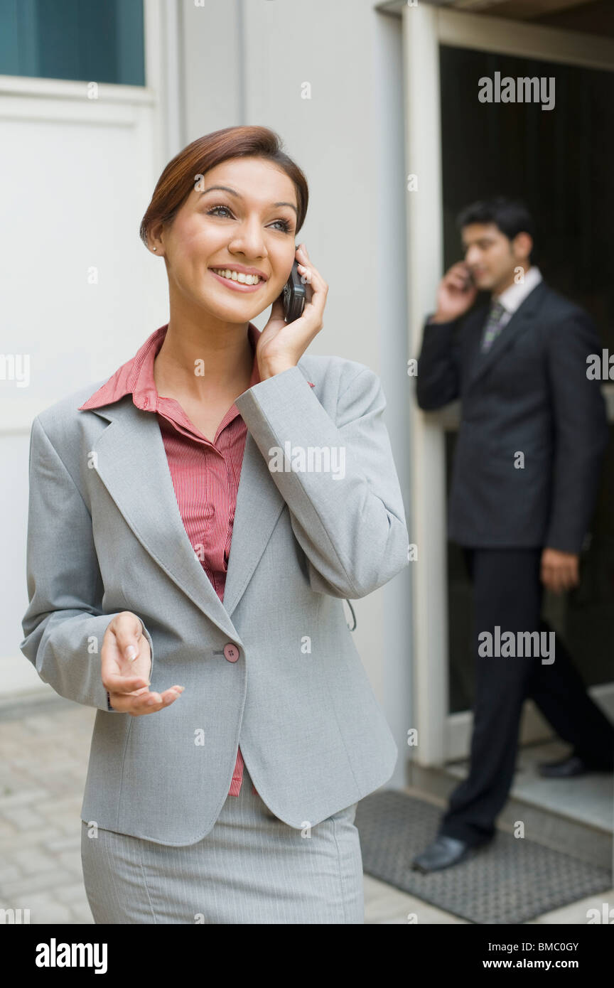 Two businessmen using cell phones hi-res stock photography and images - Alamy