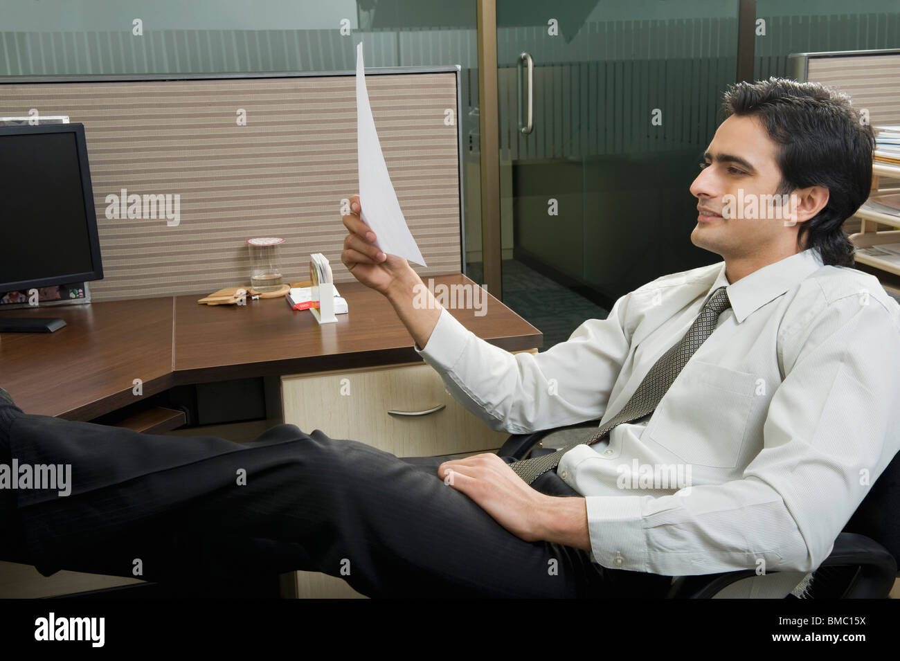 Businessman reading a document Stock Photo - Alamy
