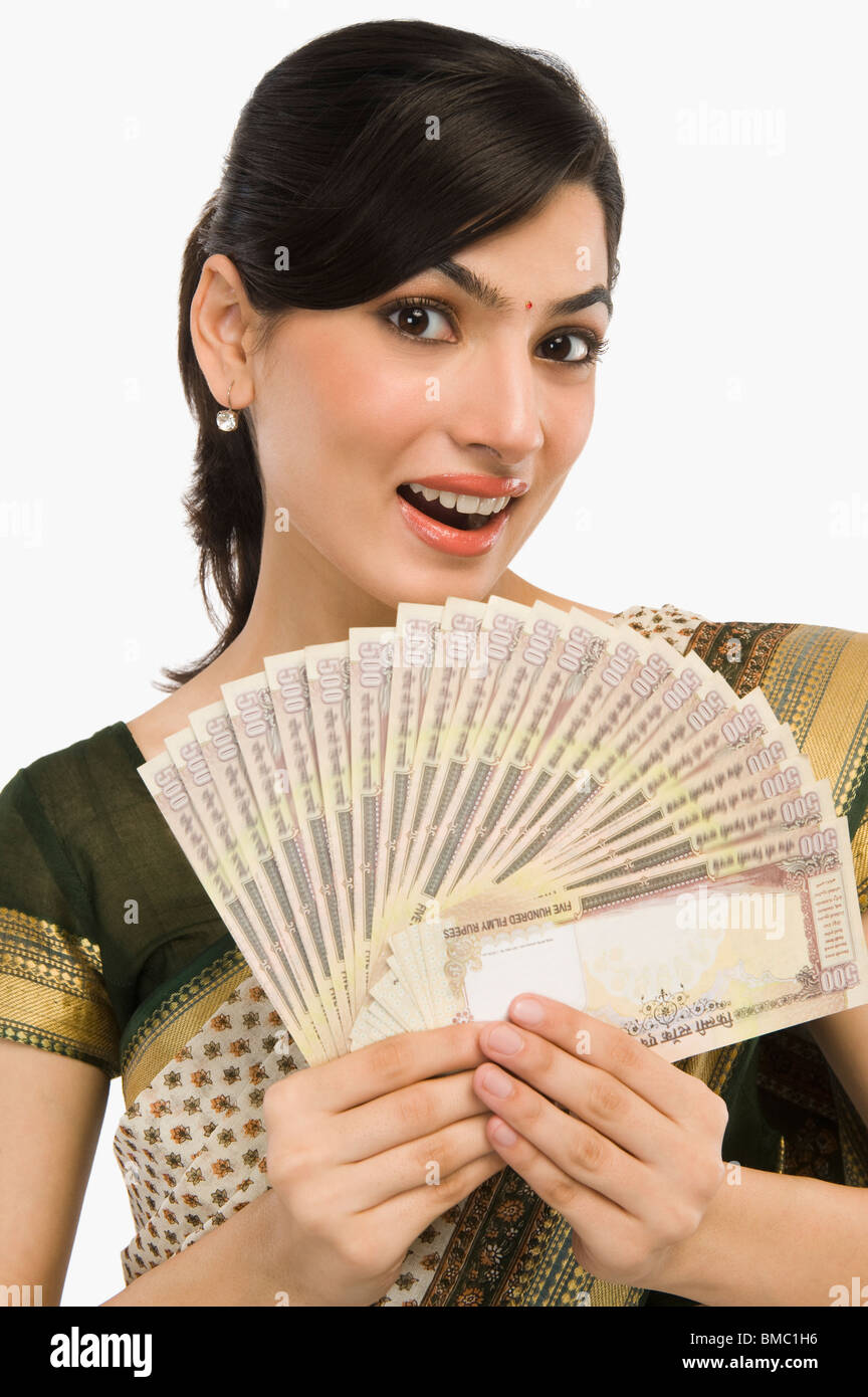 Woman holding currency notes Stock Photo - Alamy