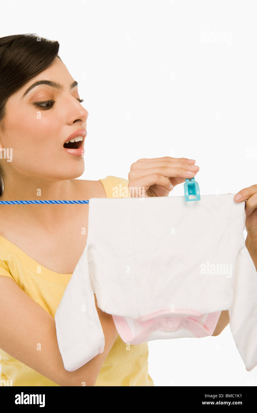 Woman hanging clothes on a clothesline Stock Photo - Alamy