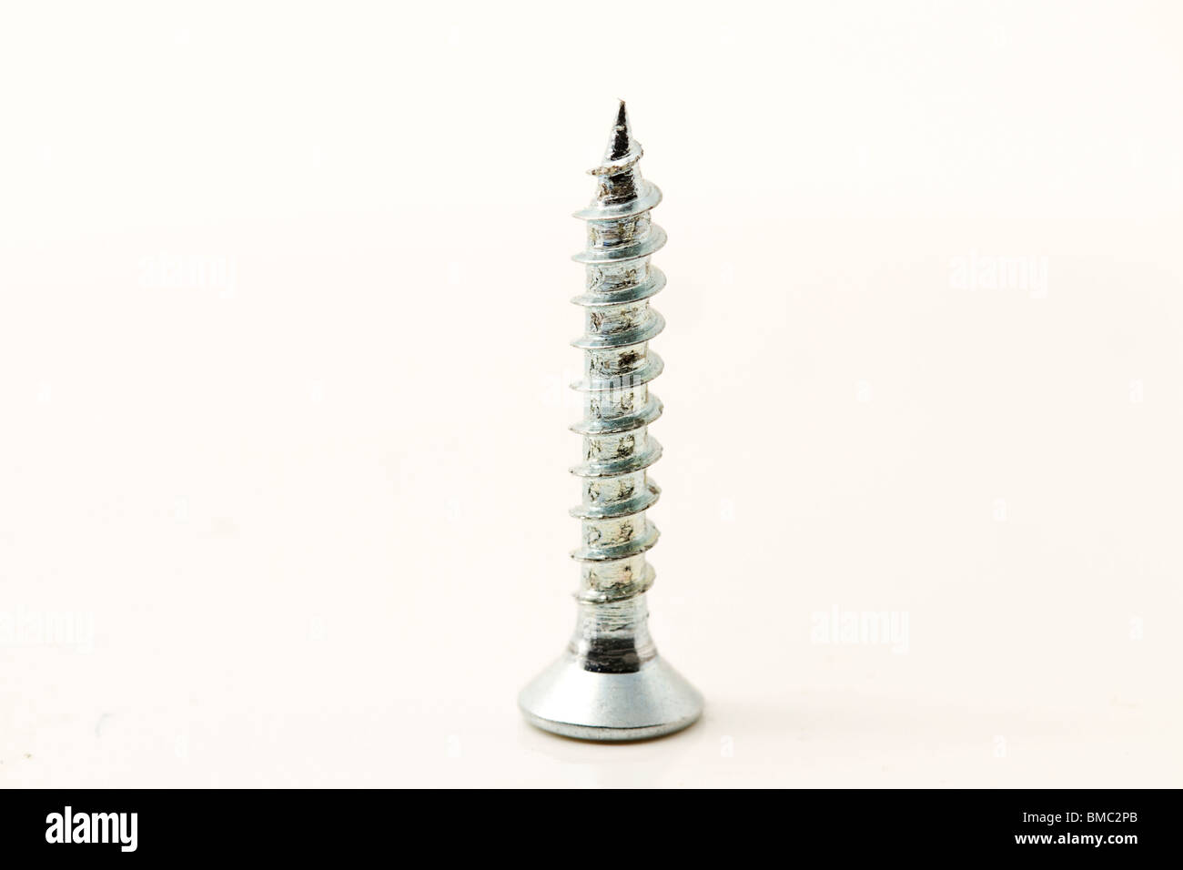 one small screw isolated on white background Stock Photo - Alamy
