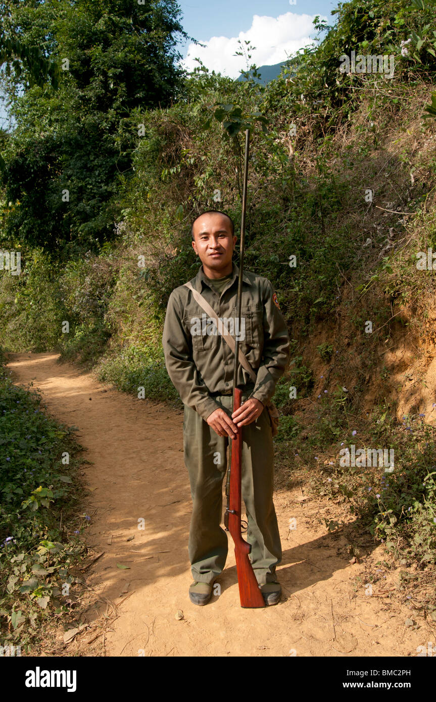 A Lao man with his gun along a jungle trail in Vong Xai province of ...