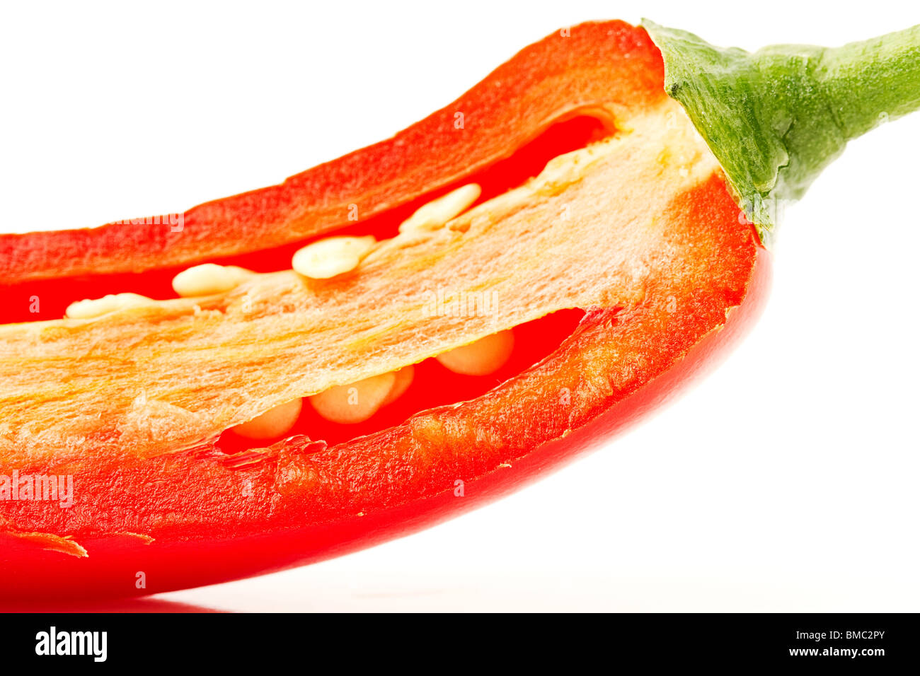 one opened chili close-up on white background Stock Photo - Alamy
