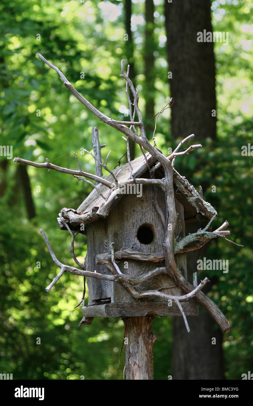 A rustic style birdhouse in a woodland garden Stock Photo - Alamy