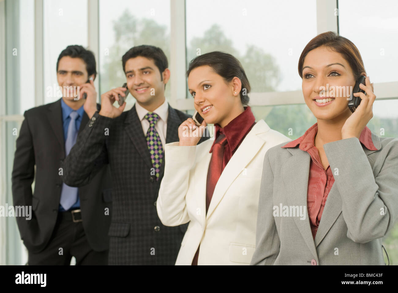 Woman on cellphone businessmen talking hi-res stock photography and ...