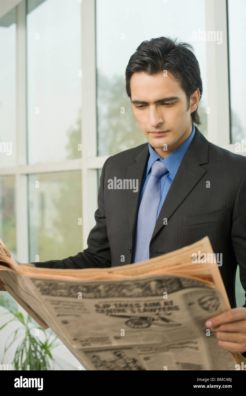 Asian indian businessman reading newspaper hi-res stock photography and ...