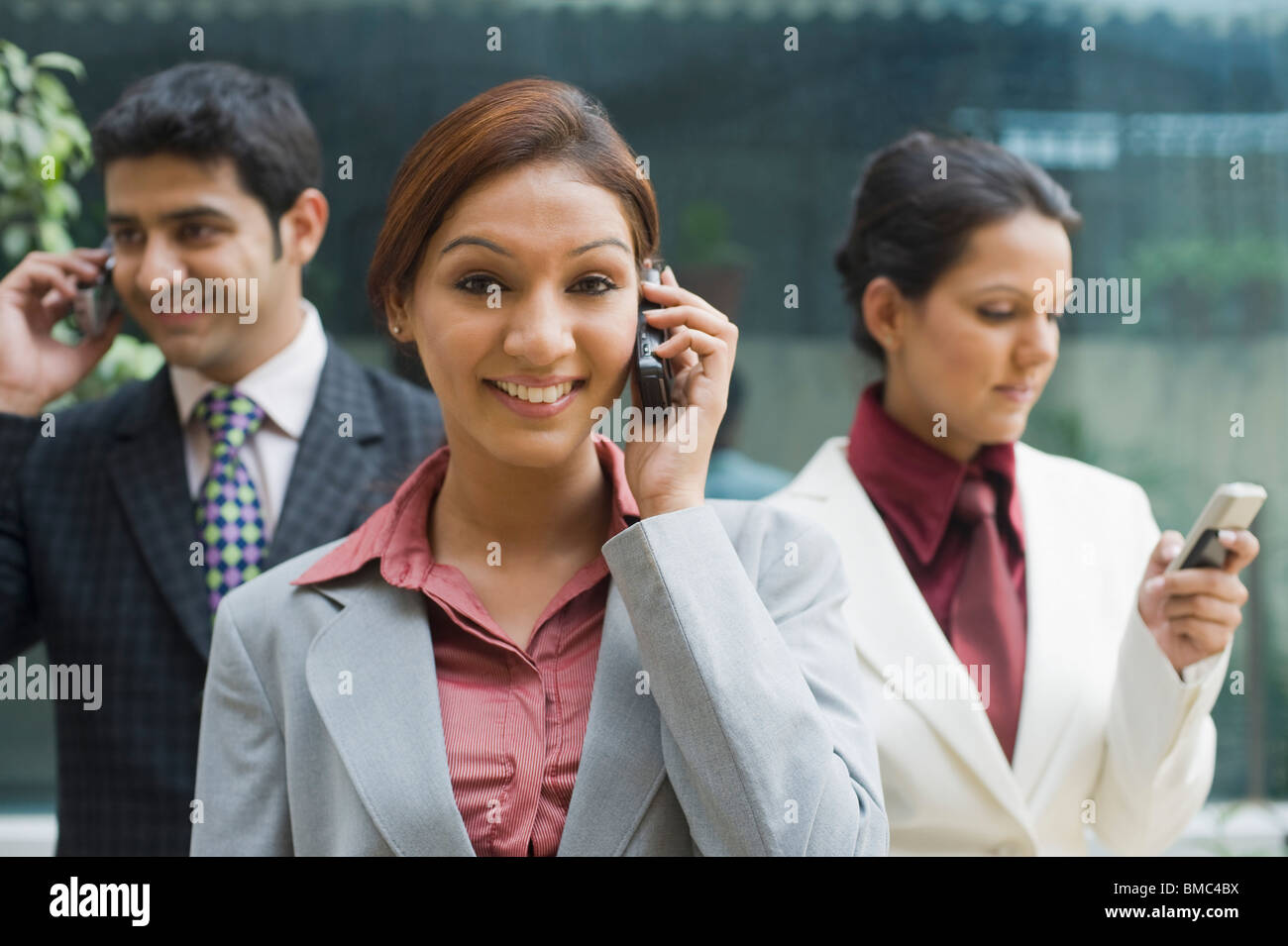 Business executives using mobile hi-res stock photography and images ...