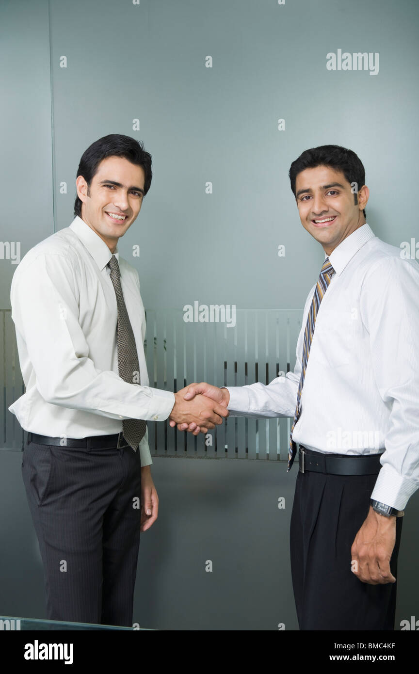 Two businessmen shaking hands Stock Photo - Alamy