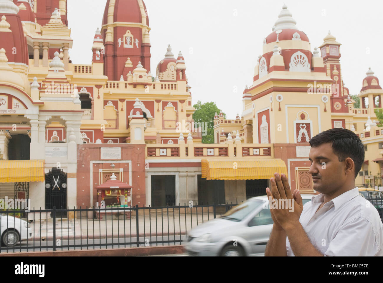 Man praying in front of a temple, Laxminarayan Temple, New Delhi, India ...