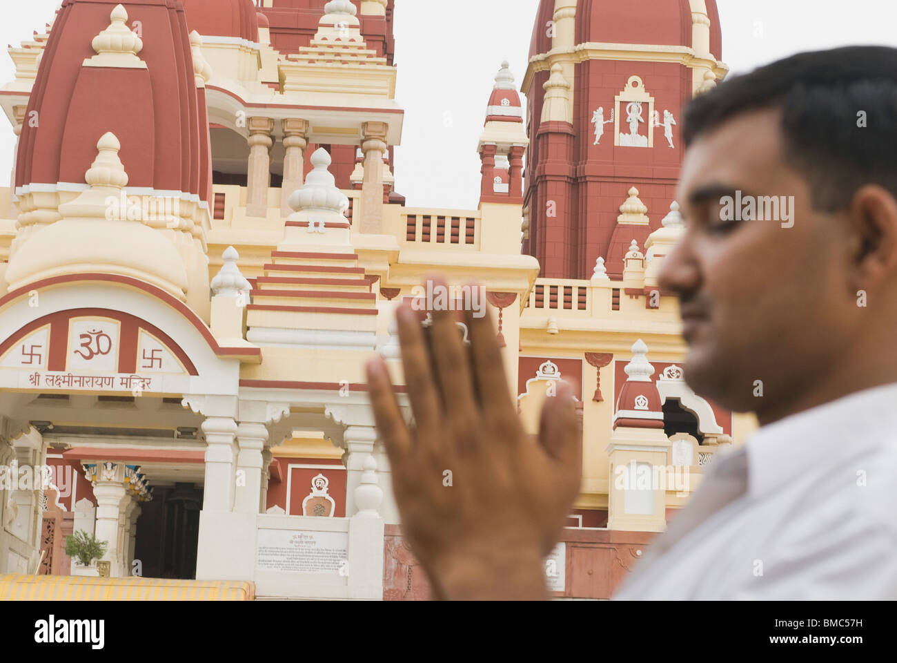 Man praying in front of a temple, Laxminarayan Temple, New Delhi, India ...