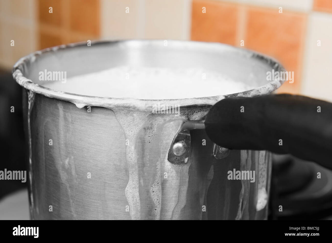 Milk boiling over a pan Stock Photo - Alamy