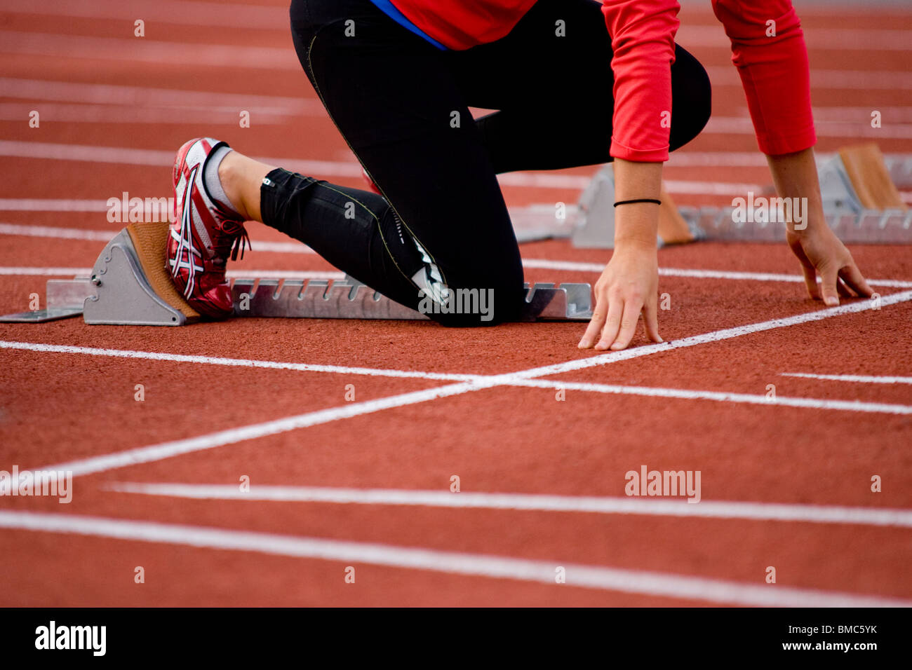 On the starting line. Young woman prepares to sprint to success Stock ...