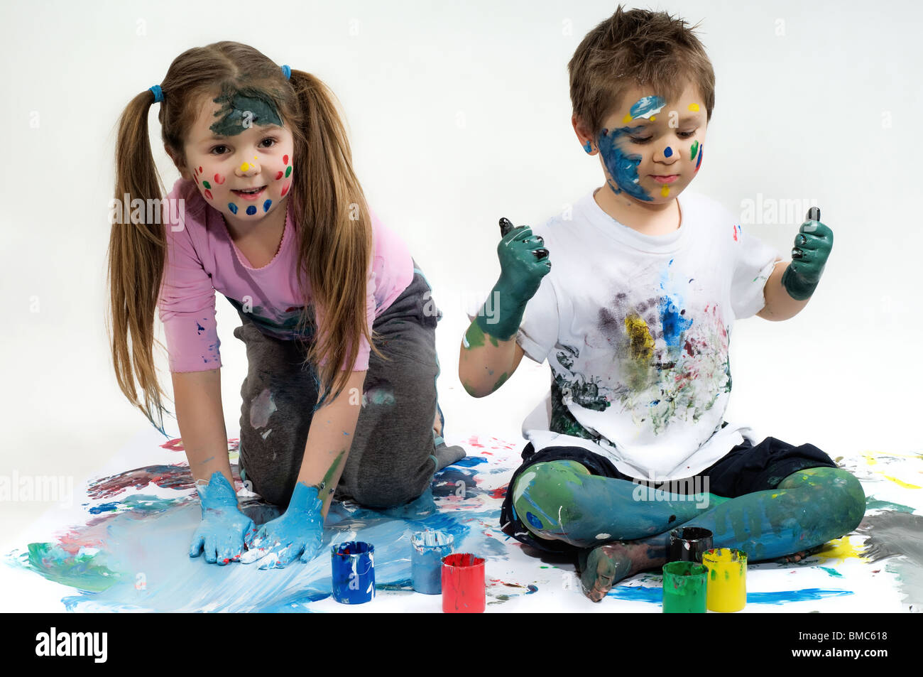 Kids having some fun with different color paints Stock Photo - Alamy