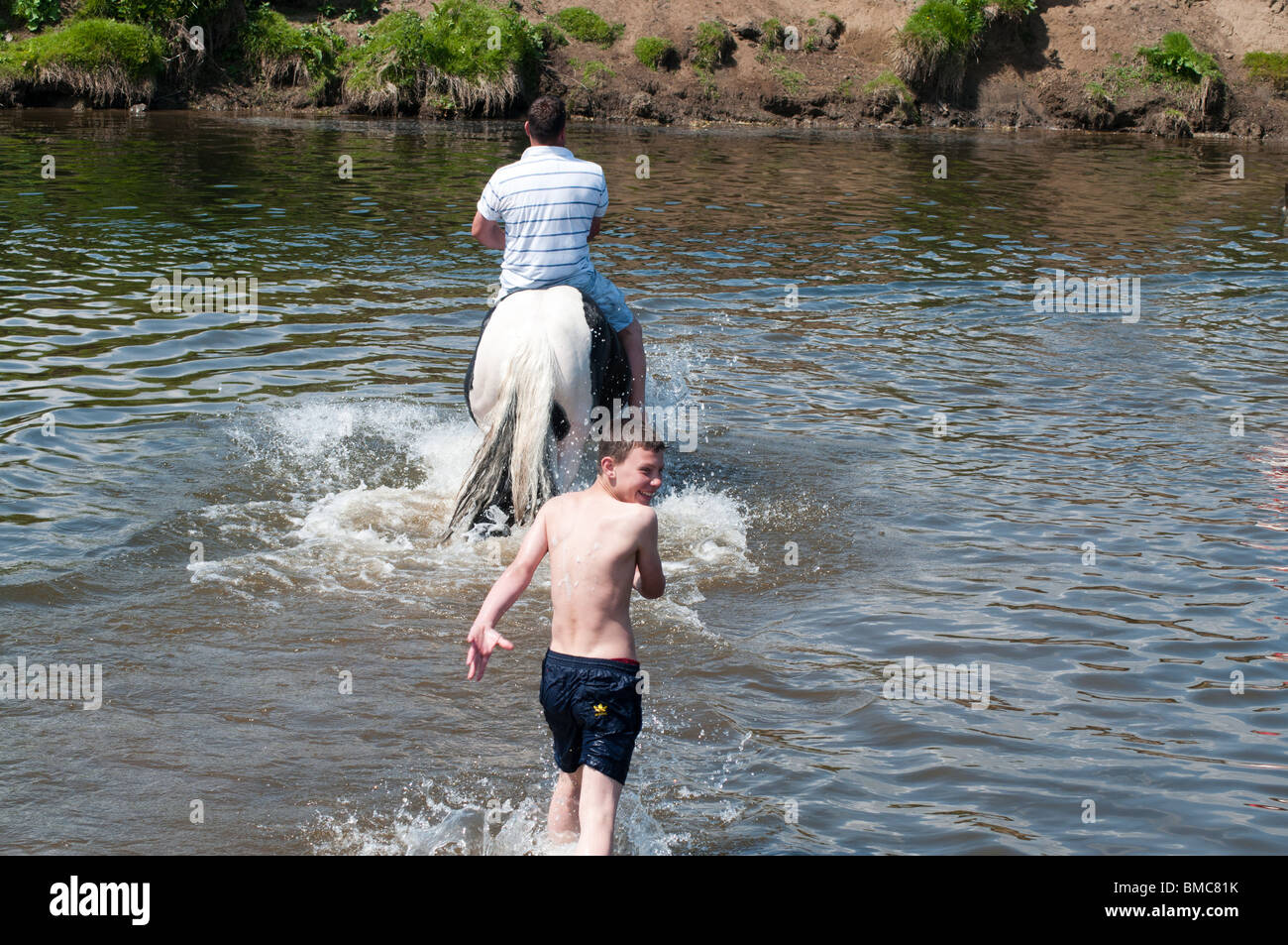 traveler boys having fun in the river Stock Photo - Alamy