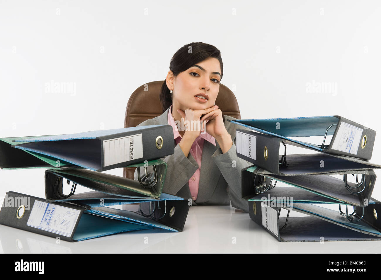 Stack of ring binders in front of a businesswoman Stock Photo - Alamy