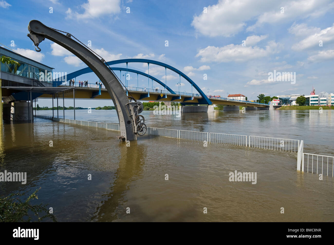 Historic harbour crane on the Oder River promenade in front of the ...