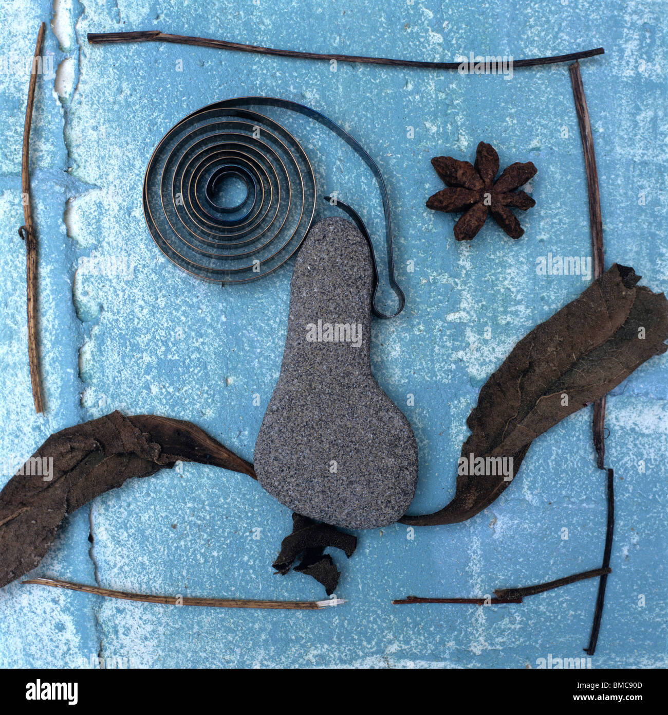 Natural materials arranged in a creative design on a textured blue ...