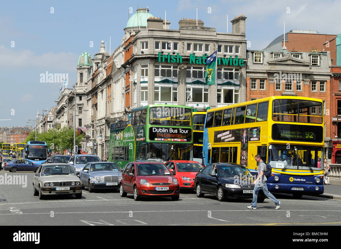 Yellow and Blue painted Dublin bus and city tour bus on O'Connell ...