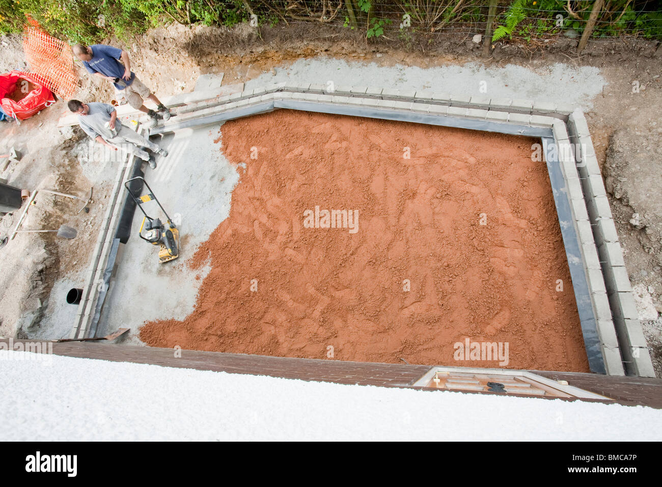 Builders prepare the floor of a house extension ready for the concrete ...