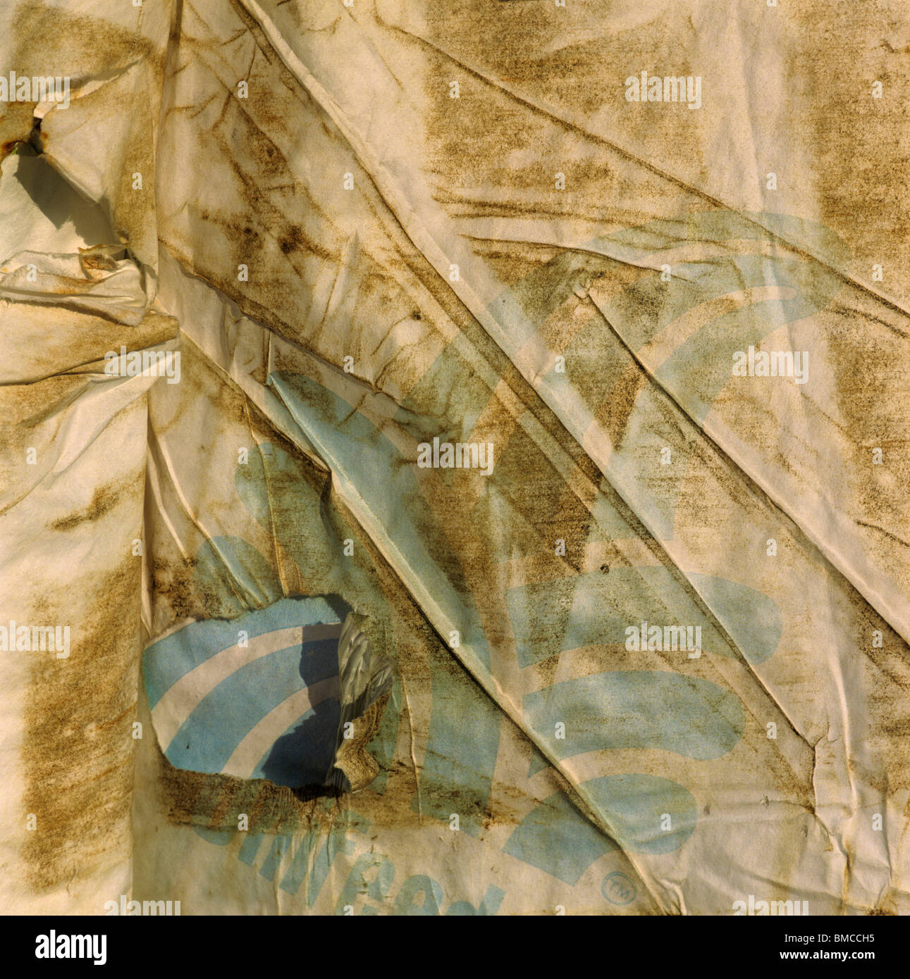 Tattered fabric with blue patterns and holes showing wear from time and ...