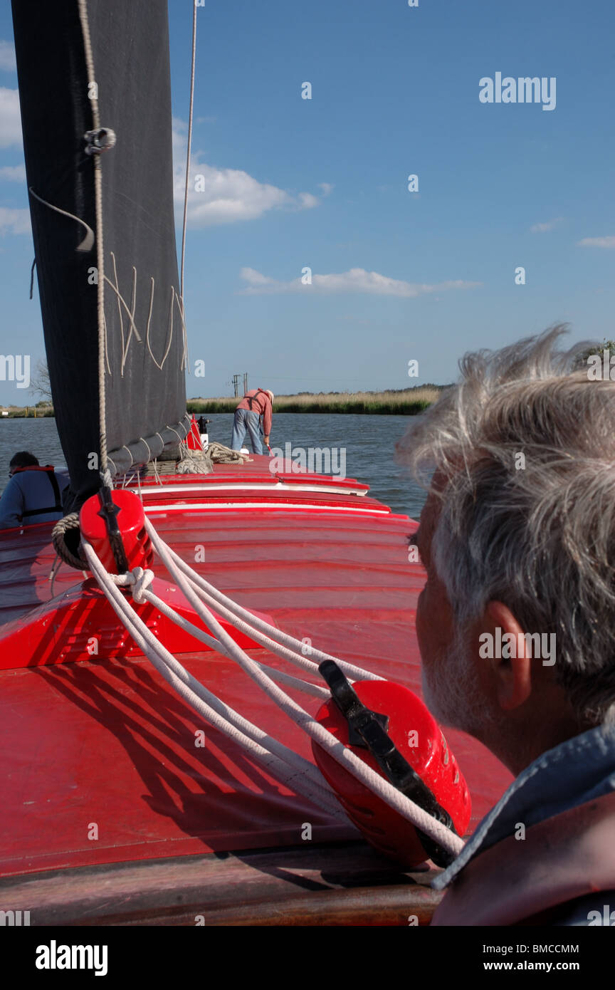 At the tiller of the historic Norfolk trading wherry Albion, sailing on ...