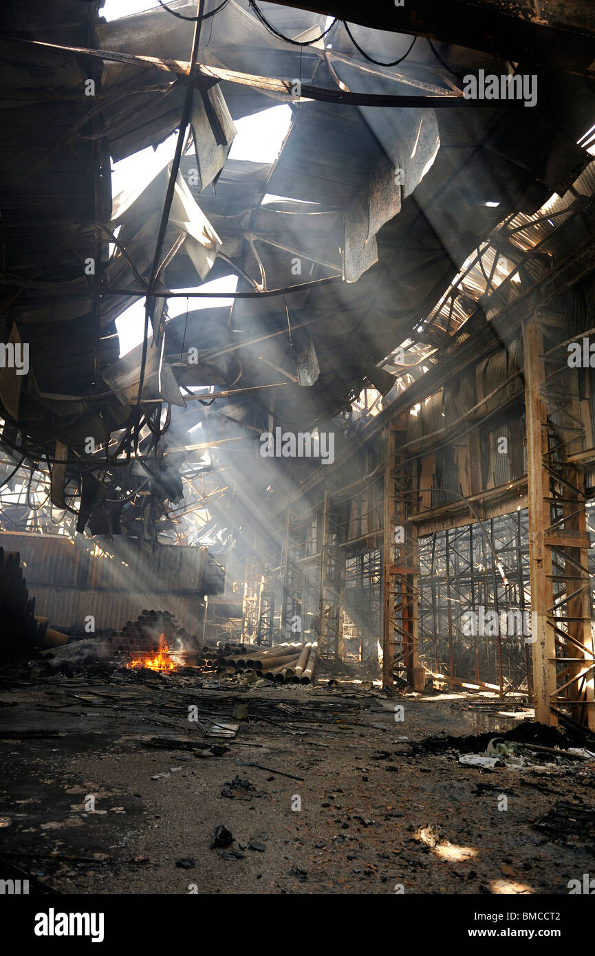 Shafts of sunlight in burnt out factory after fire Stock Photo - Alamy