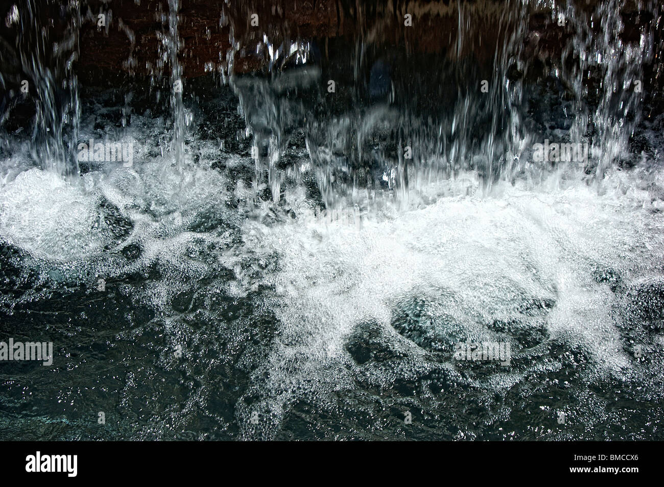 close up detail of waterfall with foaming water showing where the falls ...